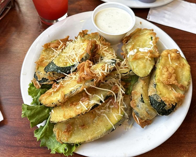 Breaded zucchini that makes eating vegetables feel like cheating. These golden-brown beauties aren't just appetizers—they're the opening act for a culinary concert.