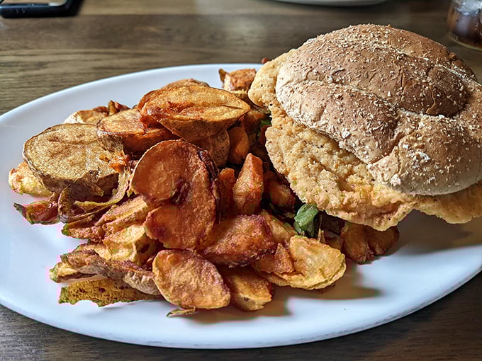 Homemade chips surround a sandwich that's built like a fortress of flavor. No wimpy lunch here—this is serious business.