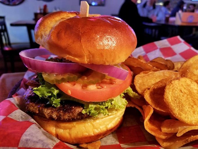 A burger stacked so perfectly it belongs in an architecture textbook, with chips that crunch loud enough to turn heads.