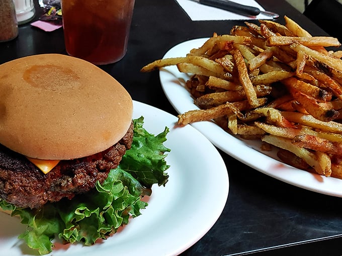 This isn't just a burger – it's the kind of honest, hand-formed patty that makes fast food chains weep with inadequacy, accompanied by fries of equal distinction.