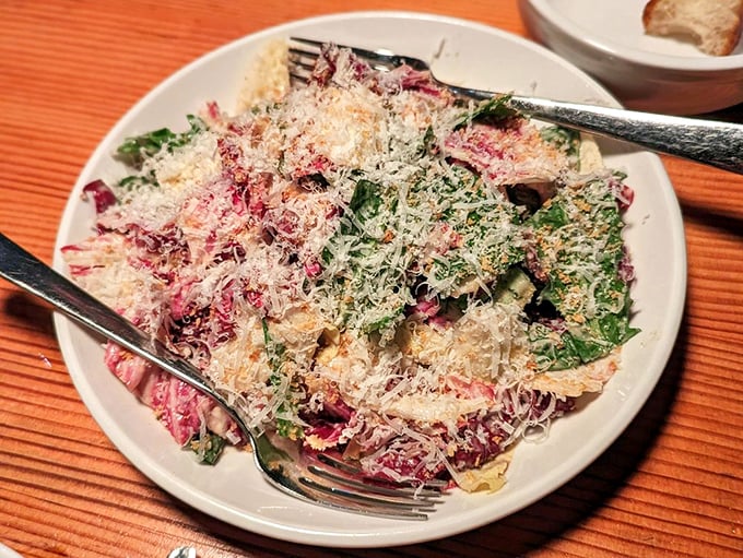 This Caesar salad isn't just a supporting player—it's a star in its own right, with shavings of cheese like confetti at a flavor parade.
