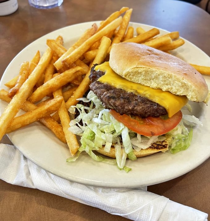 A classic American cheeseburger that doesn't need fancy aioli or artisanal buns to win your heart—just honest ingredients stacked with precision.