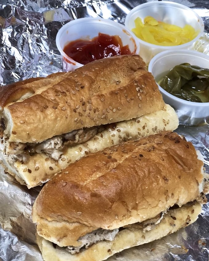 The chicken cheesesteak comes with sides of hot peppers and nostalgia—comfort food that somehow tastes better when wrapped in foil and eaten outdoors.