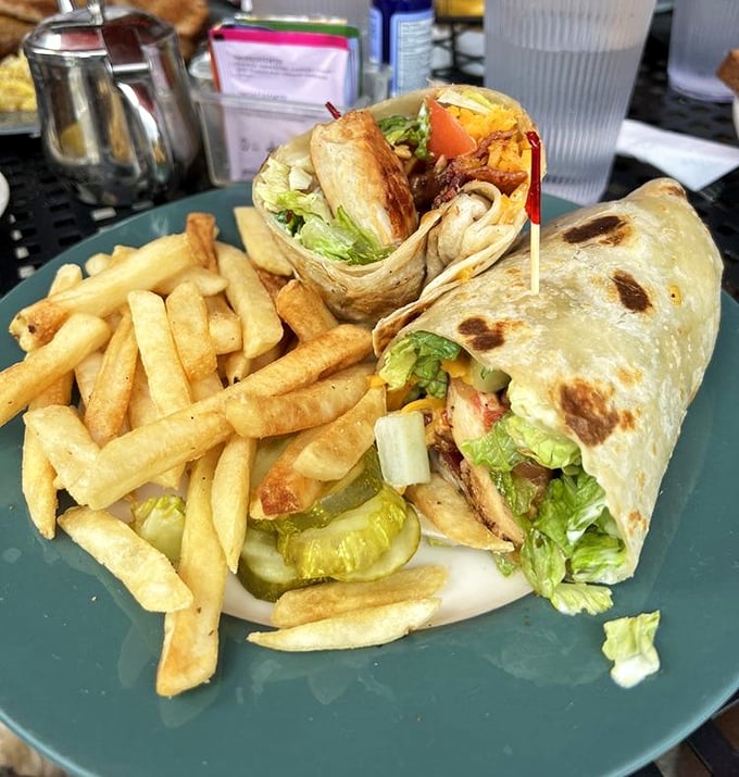 This wrap isn't messing around – packed tighter than a suitcase before vacation with fresh veggies and protein, with fries standing by for moral support.