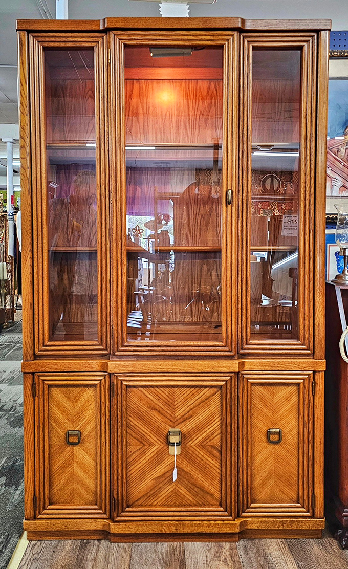 This oak china cabinet isn't just furniture—it's architectural heritage. The chevron pattern and brass pulls whisper "quality" in a way particle board never could.
