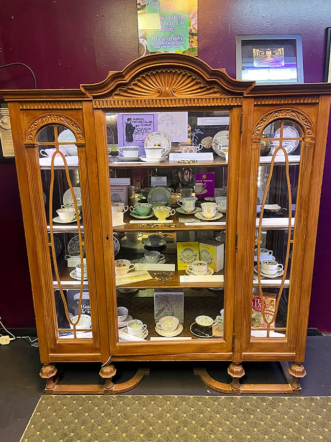 This elegant wooden cabinet displays delicate teacups used for tasseomancy—fortune-telling through tea leaves. Your grandmother's china suddenly seems rather ordinary by comparison.