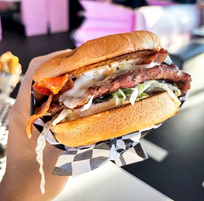 This burger doesn't just satisfy hunger – it conquers it. Melted cheese cascades over bacon and beef in a symphony of savory perfection.