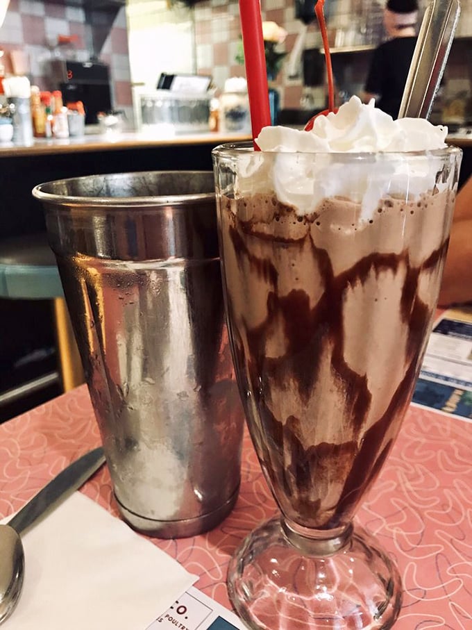 Chocolate shake perfection—the kind that makes you wonder why you ever order anything else. Extra points for the metal mixing cup on the side.