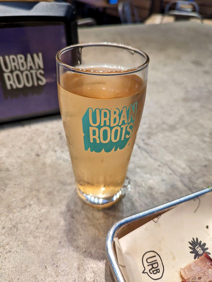 That golden pour in branded glassware isn't just beer – it's the liquid companion your smoked meat has been searching for.