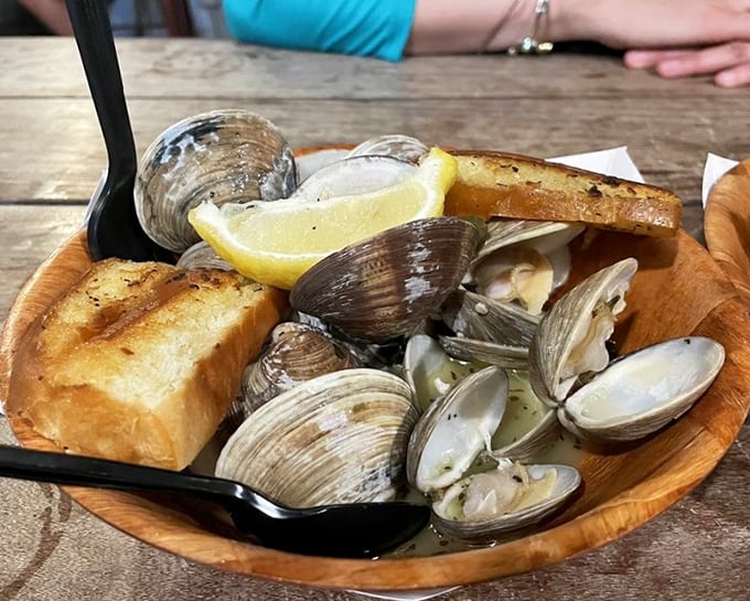 Steamed clams in their natural glory—swimming in garlicky broth with grilled bread standing by for the inevitable dipping frenzy.