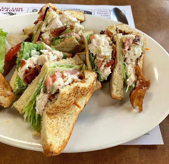 The club sandwich – a three-story monument to lunch perfection that requires both hands and possibly a strategy meeting before eating.
