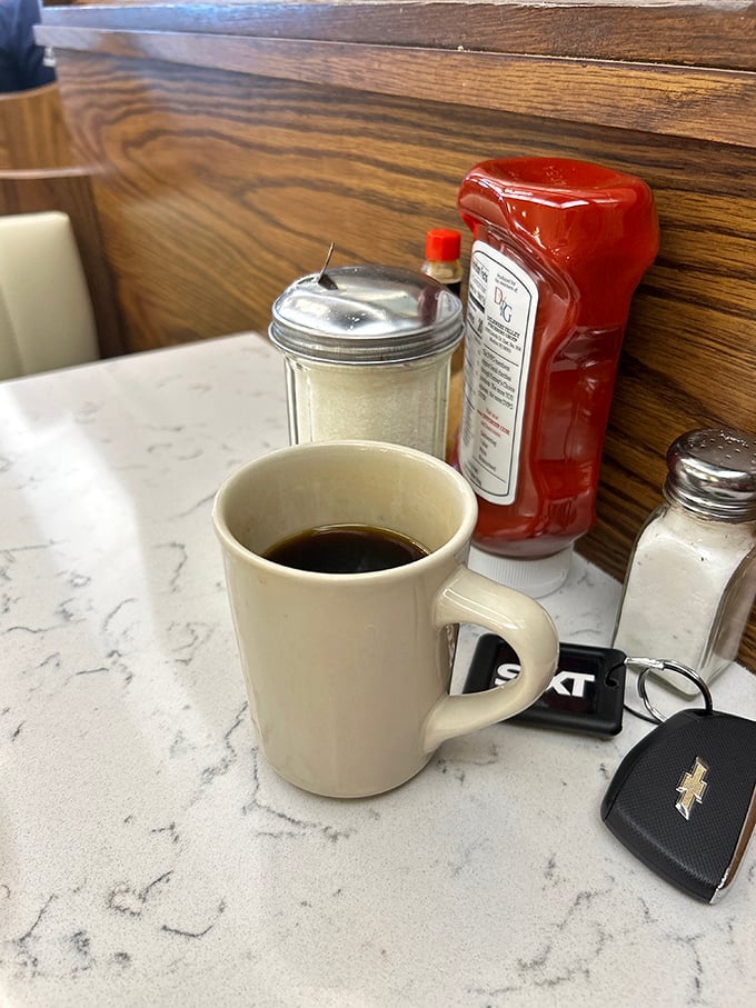 The classic diner coffee setup—where important decisions and casual gossip have equal weight. That mug has heard some stories.