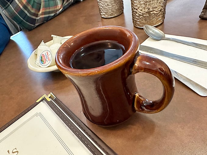 The coffee arrives in a sturdy mug that says, "I'm not here for Instagram – I'm here to properly caffeinate you for the pie decisions ahead."