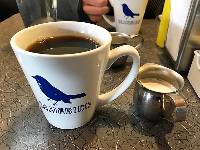 The coffee mug's blue bird isn't just a logo—it's a promise that your morning blues will fly away after the first sip.