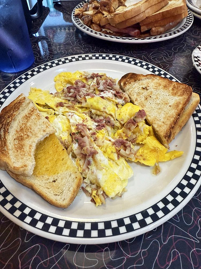 This ham and cheese omelet isn't just breakfast—it's architecture. Perfectly folded eggs housing a treasure of savory fillings alongside golden toast soldiers.
