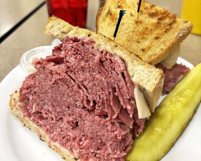This isn't just a sandwich—it's an engineering marvel. The corned beef is stacked so high it needs its own area code and possibly structural support.