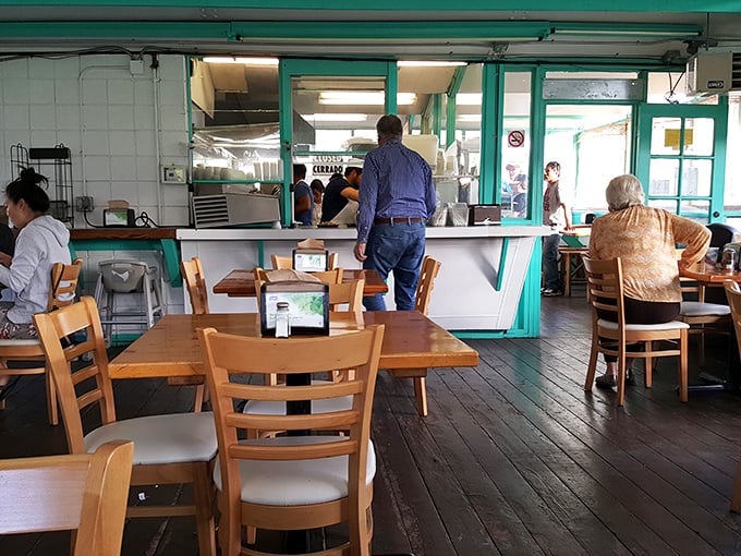 The moment of anticipation: waiting at the counter where culinary dreams are about to become delicious reality.