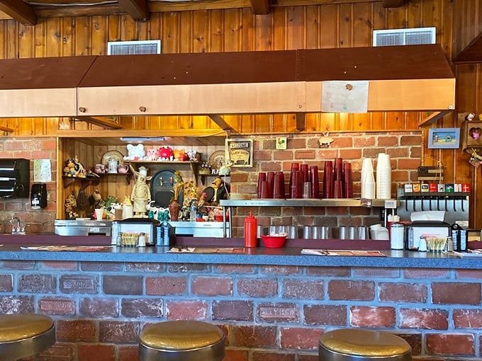 The counter where magic happens—brick, coffee machines, and the promise of hospitality that feels increasingly rare in our digital world.