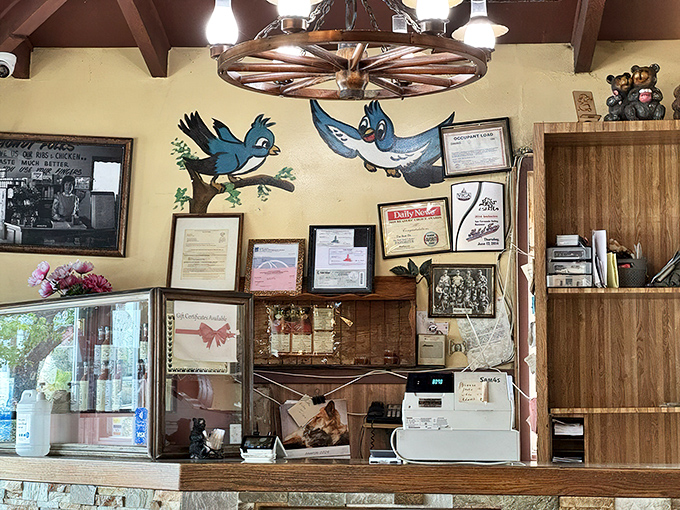 Blue jays on the wall watch over diners like BBQ guardian angels. The counter's stone facade has witnessed countless sauce-stained smiles over the years.