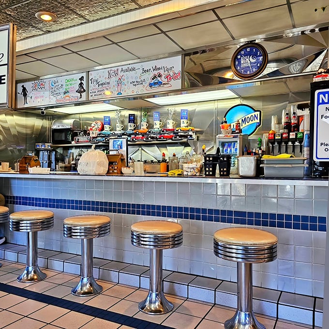 Where the magic happens—classic counter service with the rhythmic dance of short-order cooking on full display.