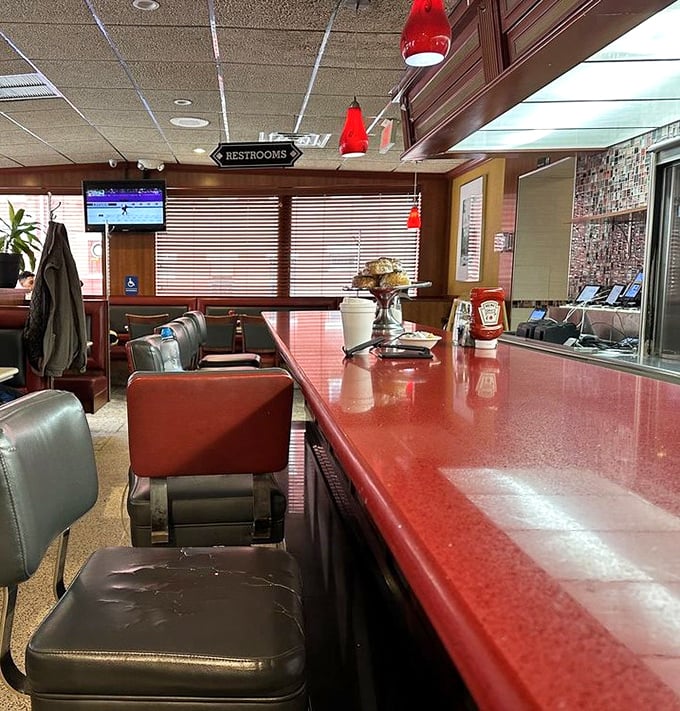 The counter area, where solo diners find community and the red vinyl stools have witnessed countless life stories over bottomless cups of coffee.