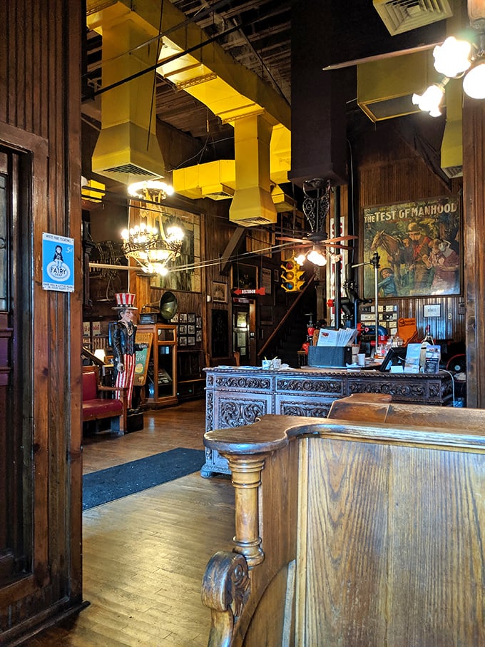The host stand looks like it was borrowed from a Victorian mansion. That wooden craftsmanship isn't just furniture—it's a portal to a more elegant dining era.