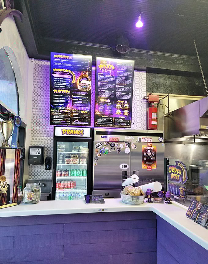 The counter where barbecue dreams come true. Purple accents and neon menus signal that this isn't your grandfather's BBQ joint—unless your grandfather was extremely cool.