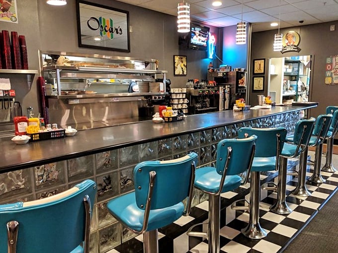 The retro counter with turquoise seats and checkerboard floor isn't just dining—it's time travel with coffee service.