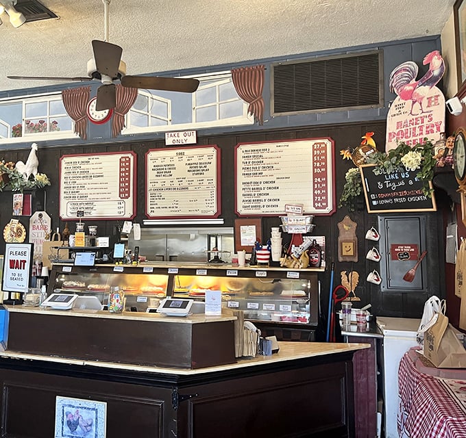 The ordering counter, where chicken dreams come true, complete with vintage rooster decorations watching over the proceedings.