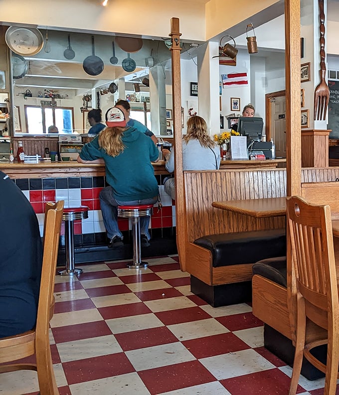 The counter seating—where solo diners become part of the family and the line between customer and friend blurs with each refill.