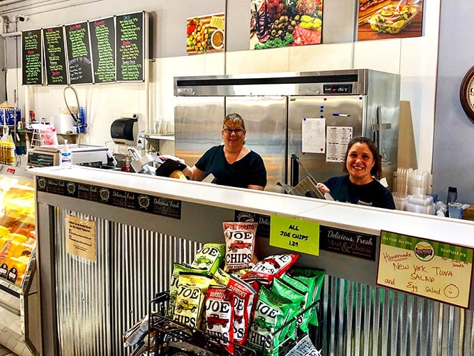 The counter where sandwich dreams come true – complete with friendly faces and a selection of chips that perfectly complement your impending feast.