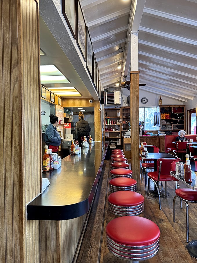 The counter view—where breakfast theater unfolds and regulars have claimed their spots through years of loyal patronage.