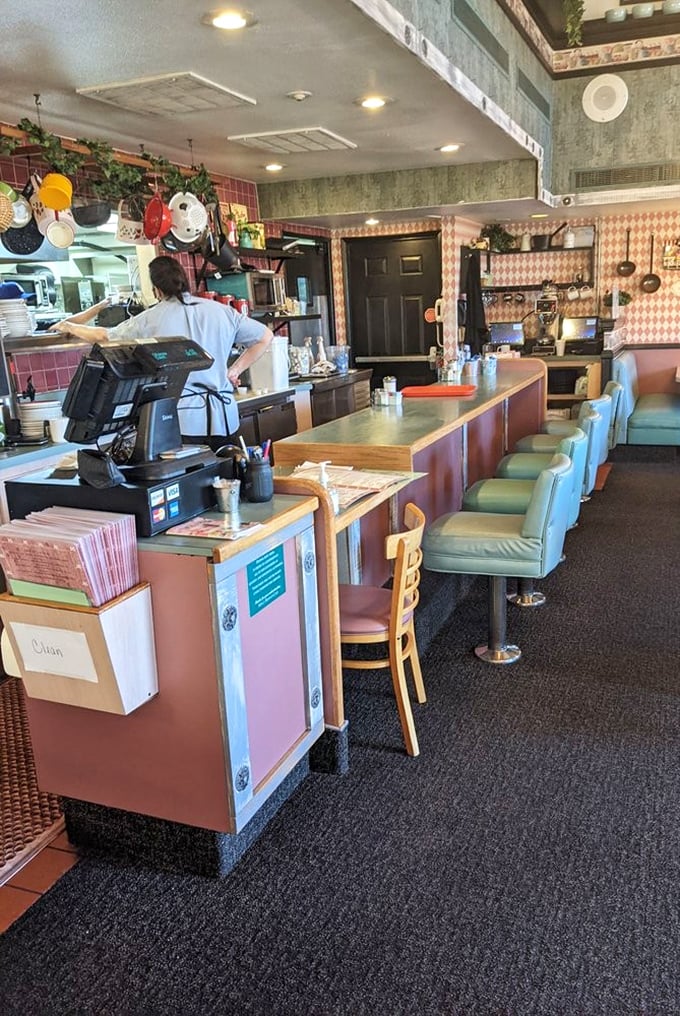 The counter seating – where solo diners become breakfast connoisseurs and servers perform their morning ballet of plates and coffee refills.