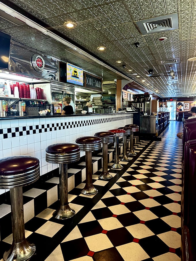 Counter seats lined up like front-row tickets to the greatest show on earth—breakfast theater with a side of people-watching.