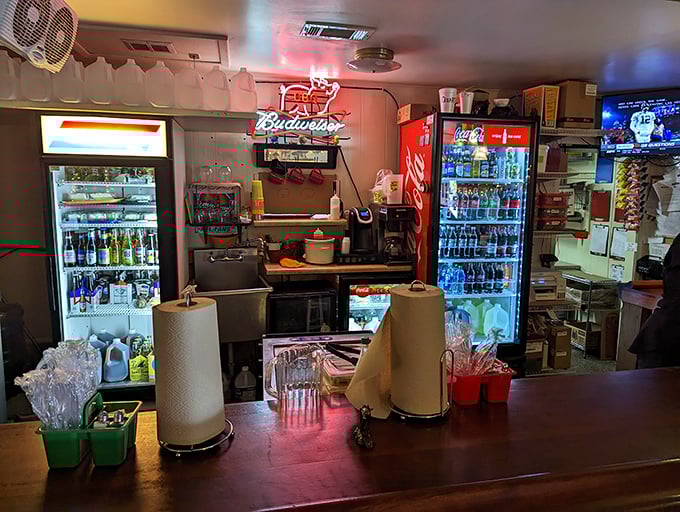 The counter area glows with neon promise—a casual reminder that cold beverages and hot barbecue form civilization's perfect partnership.