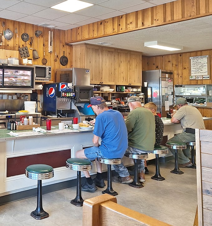 The counter seating—where solo diners become part of the community and regulars hold court. Democracy in action, with hash browns.
