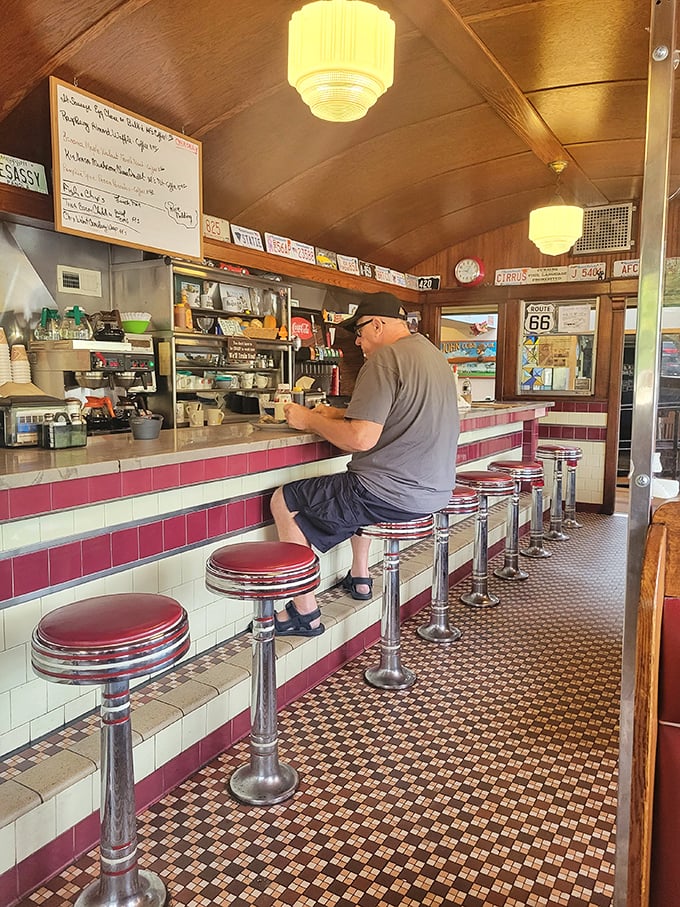The counter—where solo diners find community, coffee cups are never empty, and you can watch breakfast ballet performed by skilled short-order cooks.