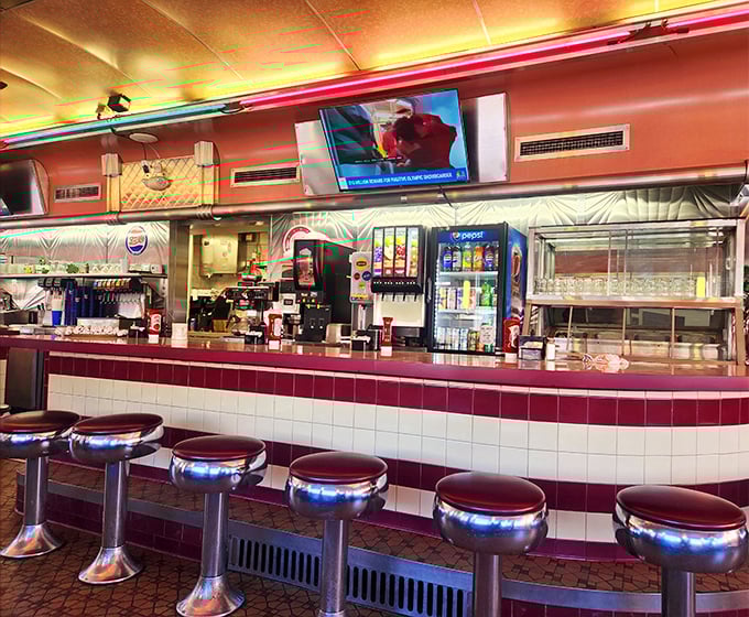 The counter and stools—where solo diners become temporary neighbors, united by the universal language of "pass the ketchup, please."