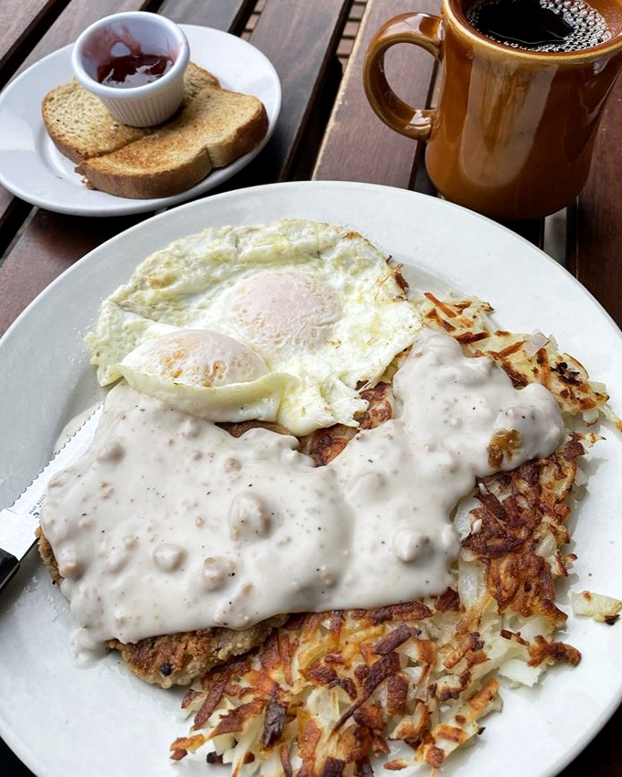 Country fried steak smothered in peppery gravy alongside sunny-side-up eggs—comfort food that hugs you from the inside out.