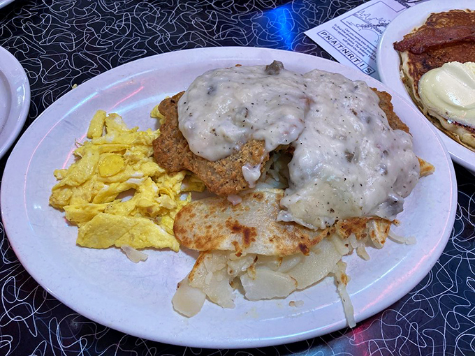 The country fried steak—golden, crispy, and smothered in gravy that could make a vegetarian question their life choices.