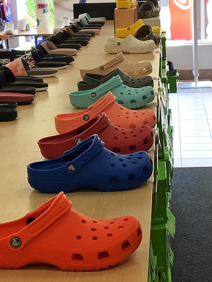 A rainbow regiment of Crocs stands at attention, proving that comfort and fashion have finally called a colorful truce after decades of feuding.