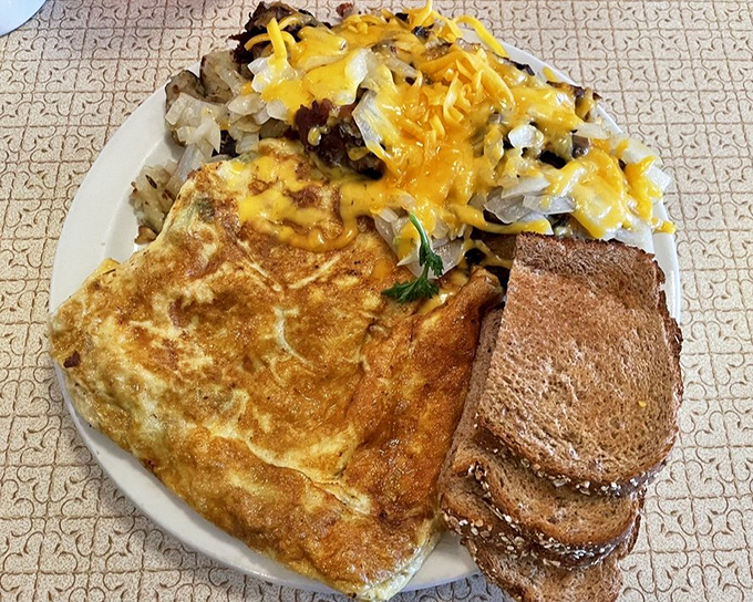 A proper diner omelet doesn't hide behind fancy ingredients—it proudly displays its golden exterior and generous fillings like medals of honor.