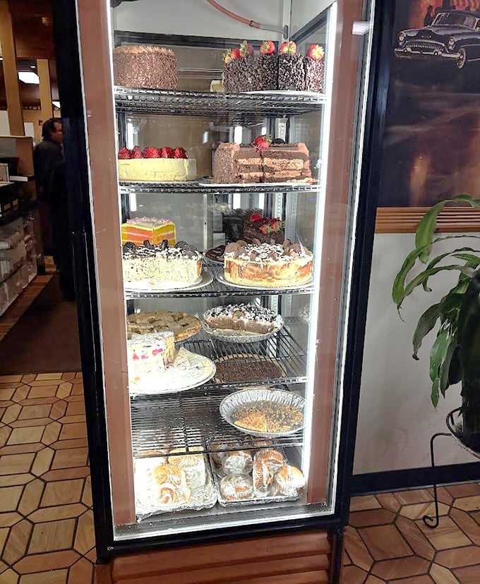The dessert case—a glass-enclosed museum of temptation where willpower goes to die and diet plans are forgotten.