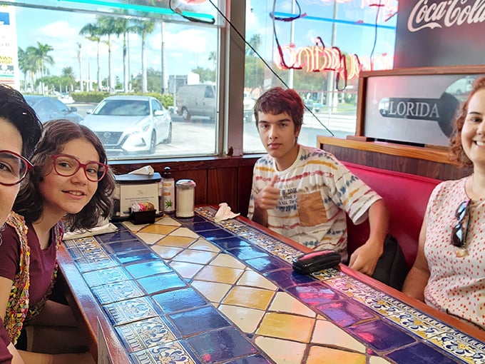 The colorful tile tables add a distinctly Miami flair to the classic diner experience, making every booth feel special.