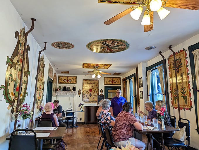 A dining room where conversations flow as freely as the gravy. The folk art adorning the walls isn't decoration—it's a cultural immersion course.