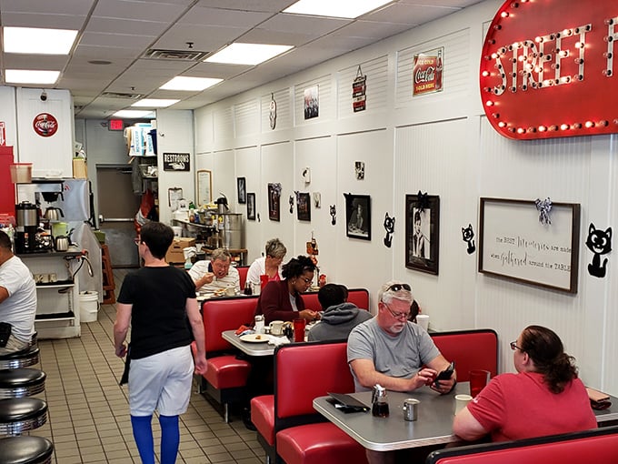 Red booths filled with diners experiencing breakfast bliss. Notice nobody's on their phone—they're too busy having religious experiences with their pancakes. 