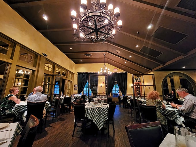The vaulted ceilings and elegant chandeliers create an atmosphere where you feel both special and completely at home—like dining in a fancy friend's living room.