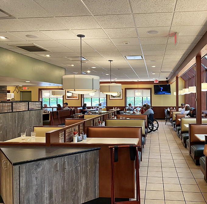The dining area's warm tones and comfortable booths invite you to settle in, a breakfast sanctuary where coffee flows and conversation follows.