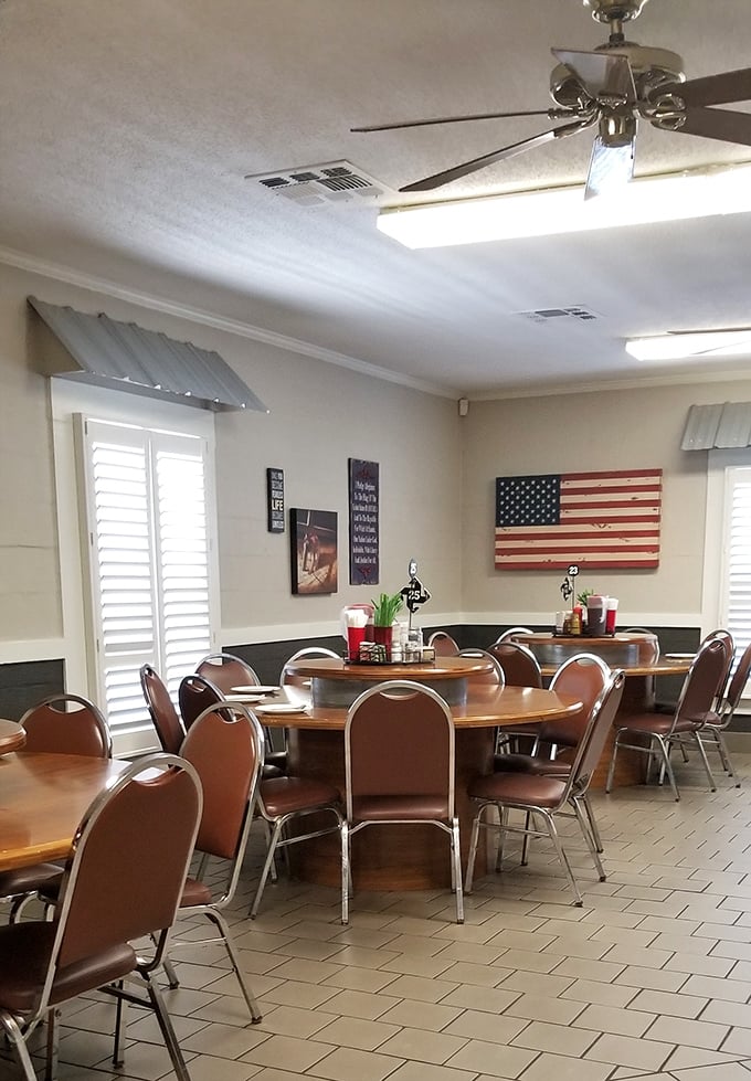 Round tables with lazy Susans await beneath ceiling fans and American flags—a dining room that says "take your time, stay awhile."