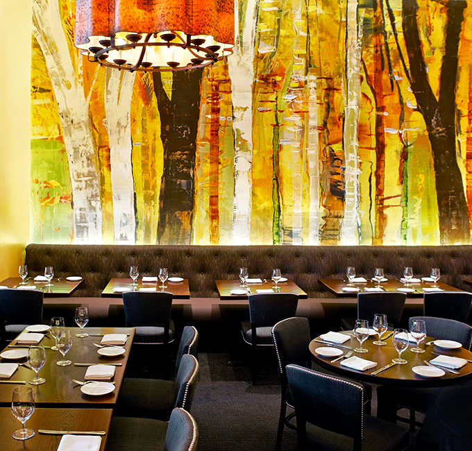 The dining room where food dreams come true. That statement wall art creates the perfect backdrop for plates that are equally artistic.